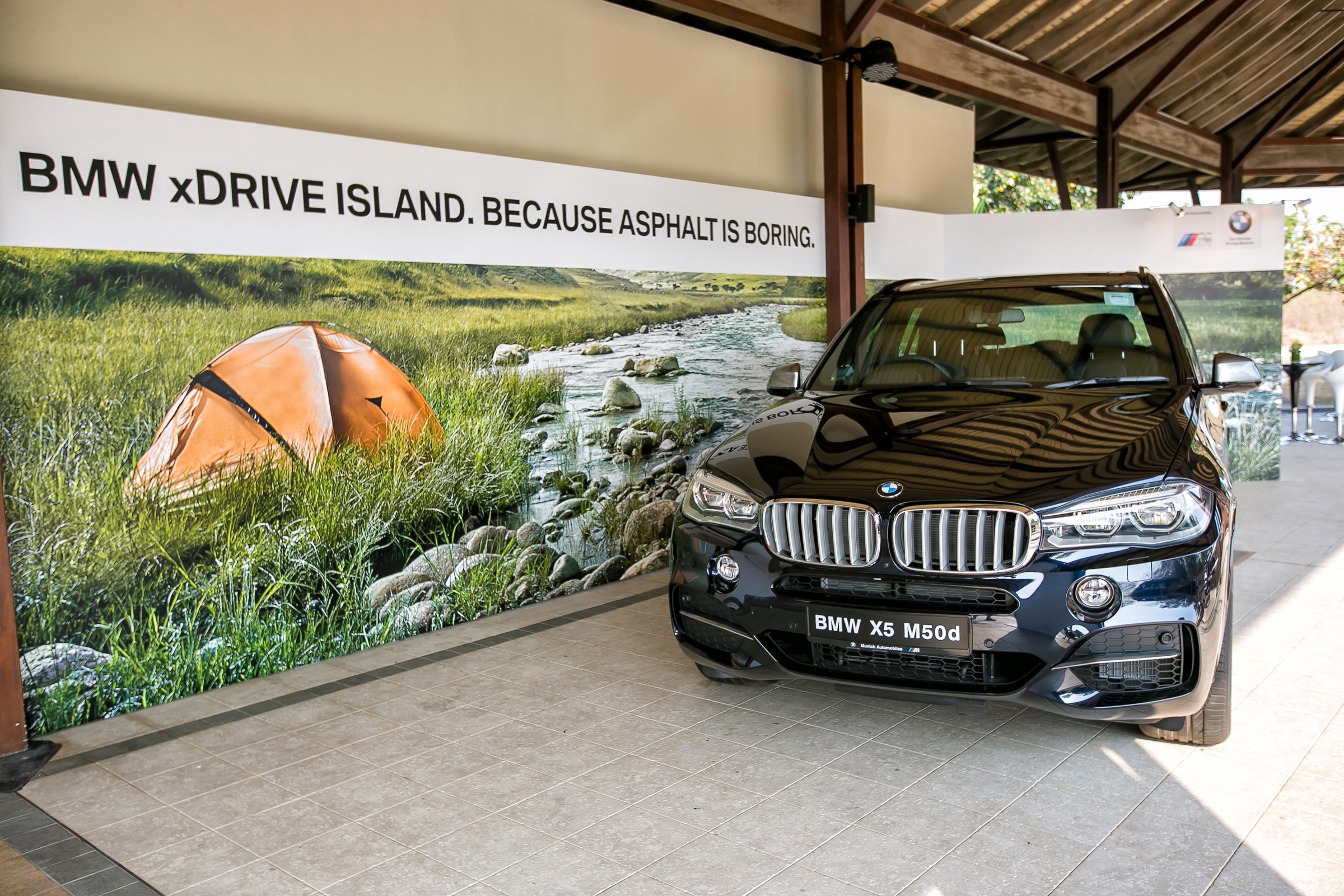 Behind the wheels of BMW X5 and kicking up a storm on a private island ...
