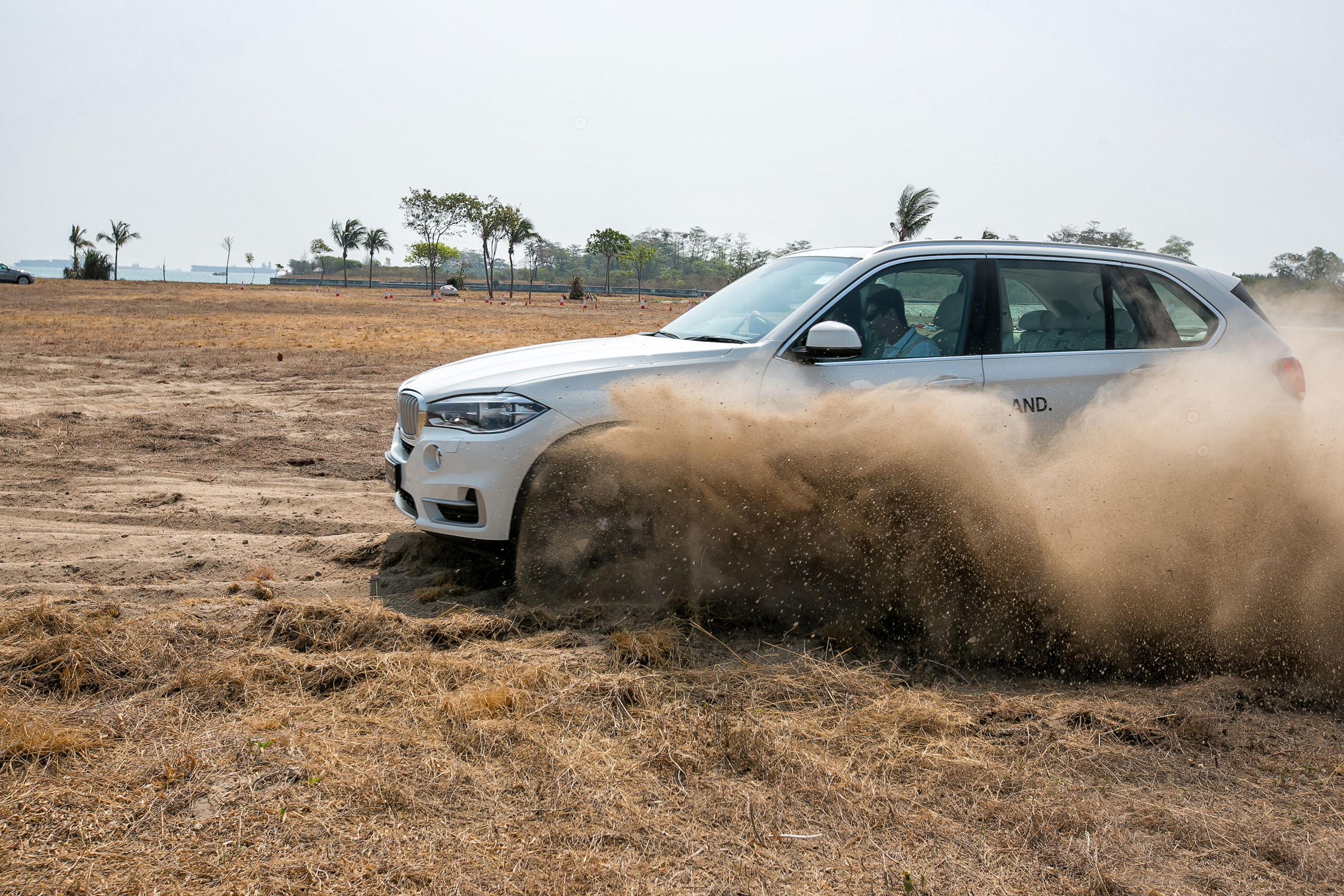 Behind the wheels of BMW X5 and kicking up a storm on a private island ...