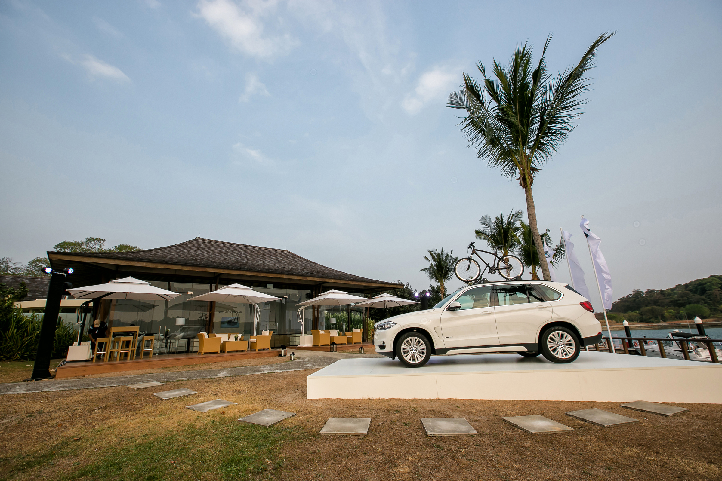 Behind the wheels of BMW X5 and kicking up a storm on a private island ...